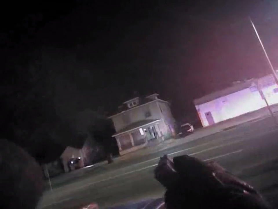 View from Sergeant in front of house shows Andrew Finch in the doorway ...