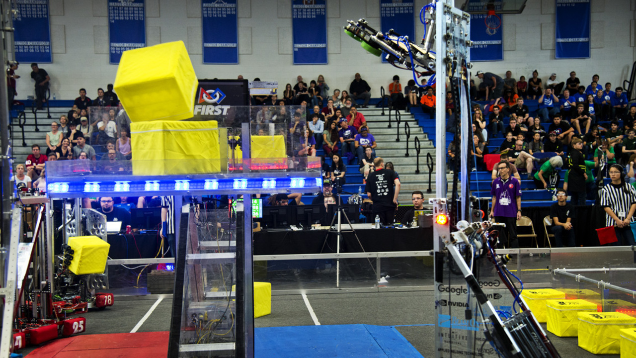 Robots built and controlled by high school students carry out a variety ...