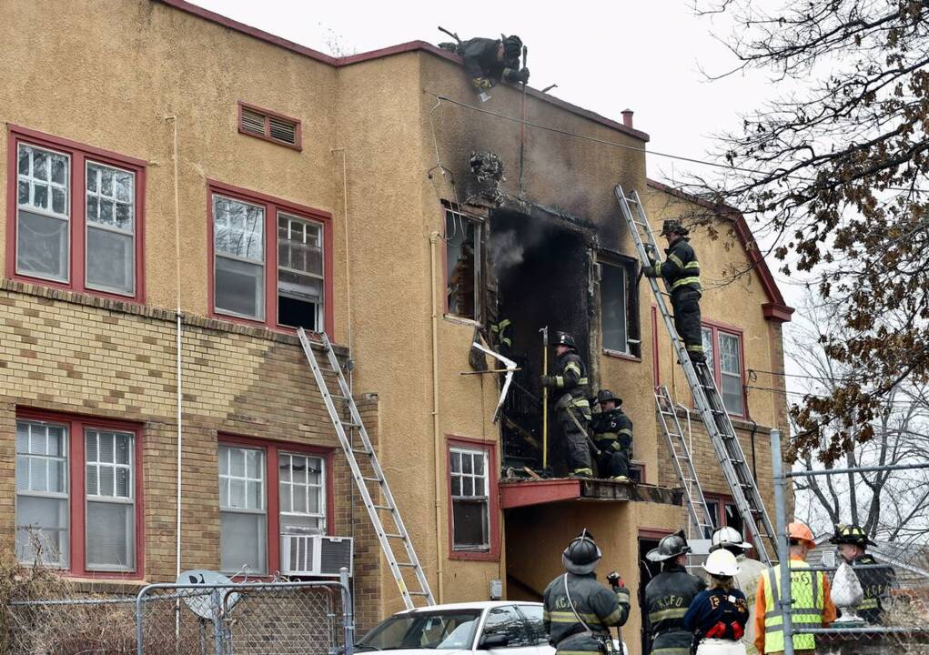Firefighters work to extinguish apartment building fire in Kansas City ...