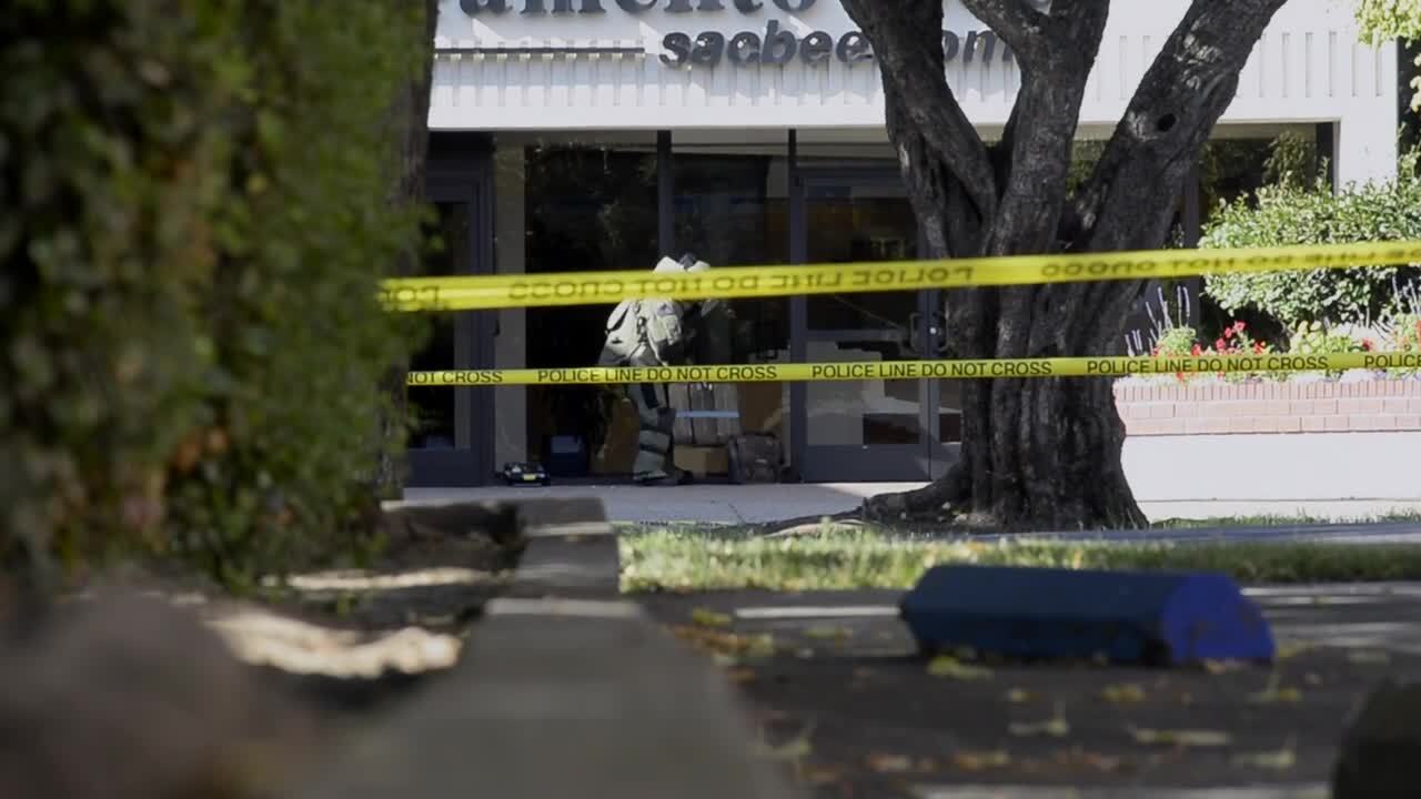 Sacramento police bomb squad members inspect the suspicious package ...
