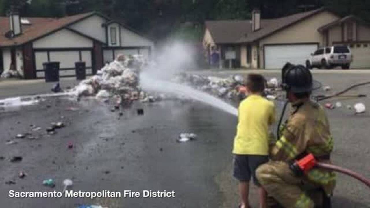 Kids help firefighters douse blaze after driver dumps load of flaming ...