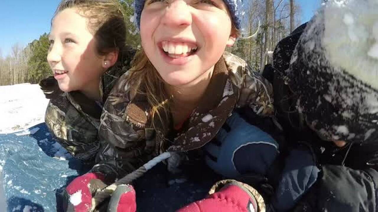 Children enjoy the snow day sledding on a car hood in Aynor | Biloxi ...