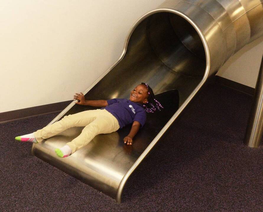 Students enjoy slide inside Invest Collegiate: Transform charter school ...