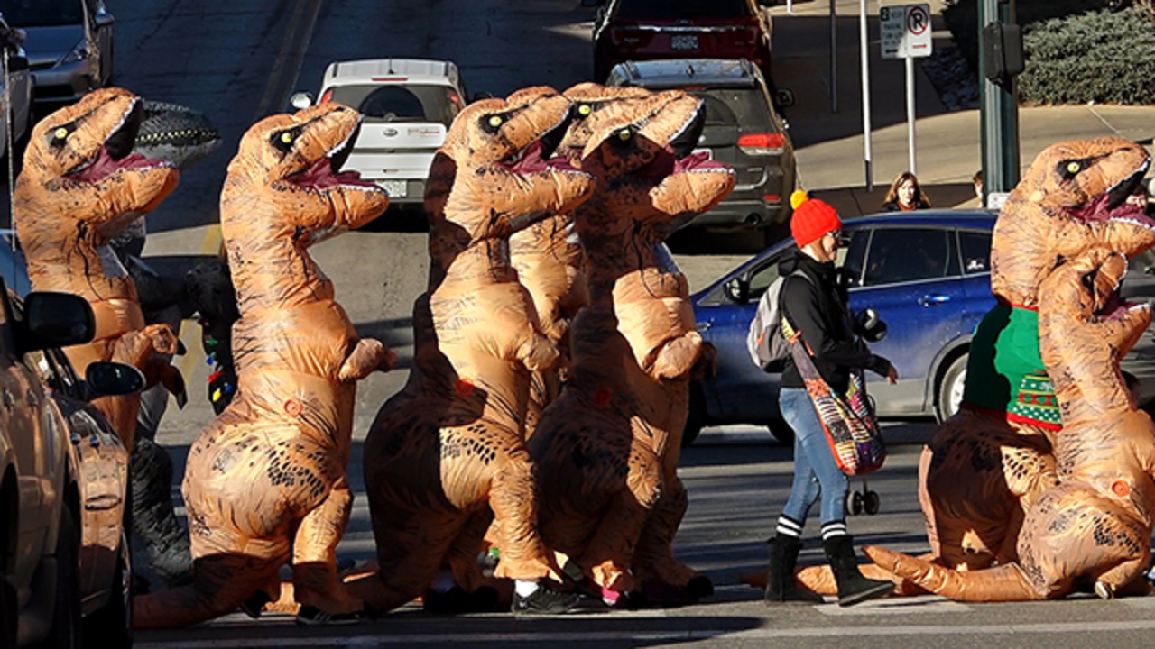 Marching dinosaurs delight Christmas shoppers on the Country Club Plaza ...