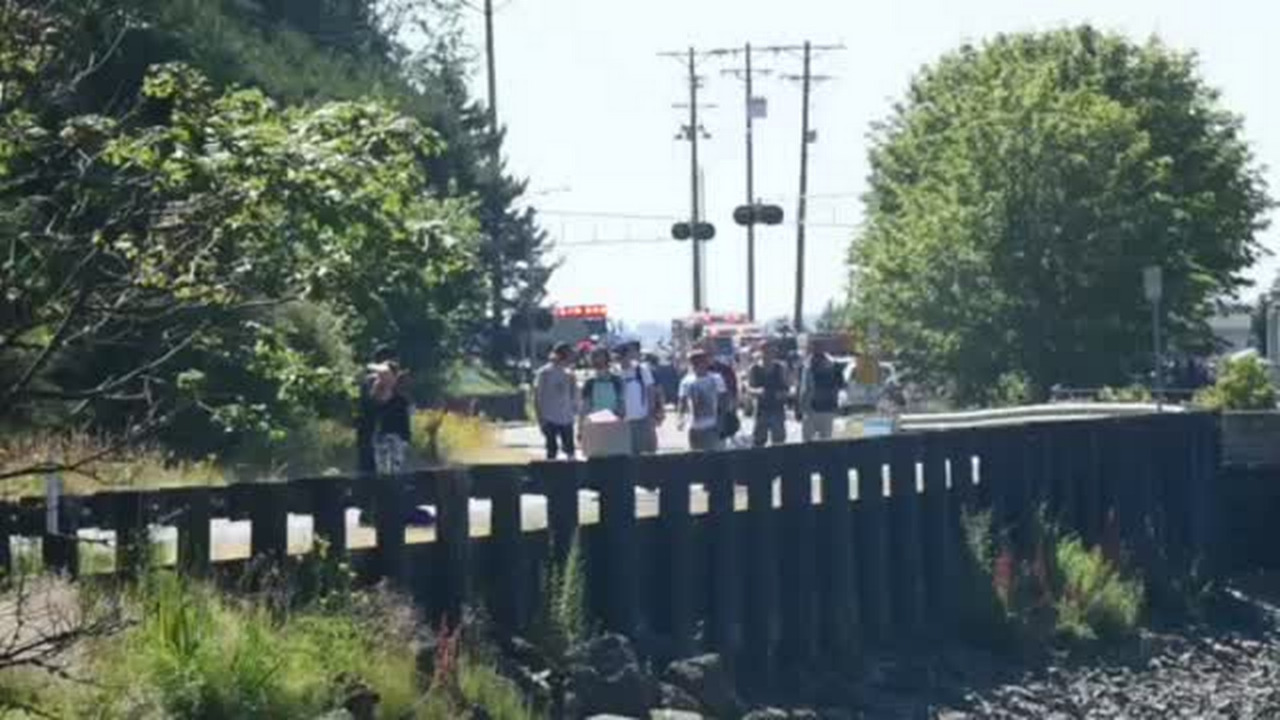 Train passengers leave the site of an Amtrak derailment near Chambers ...